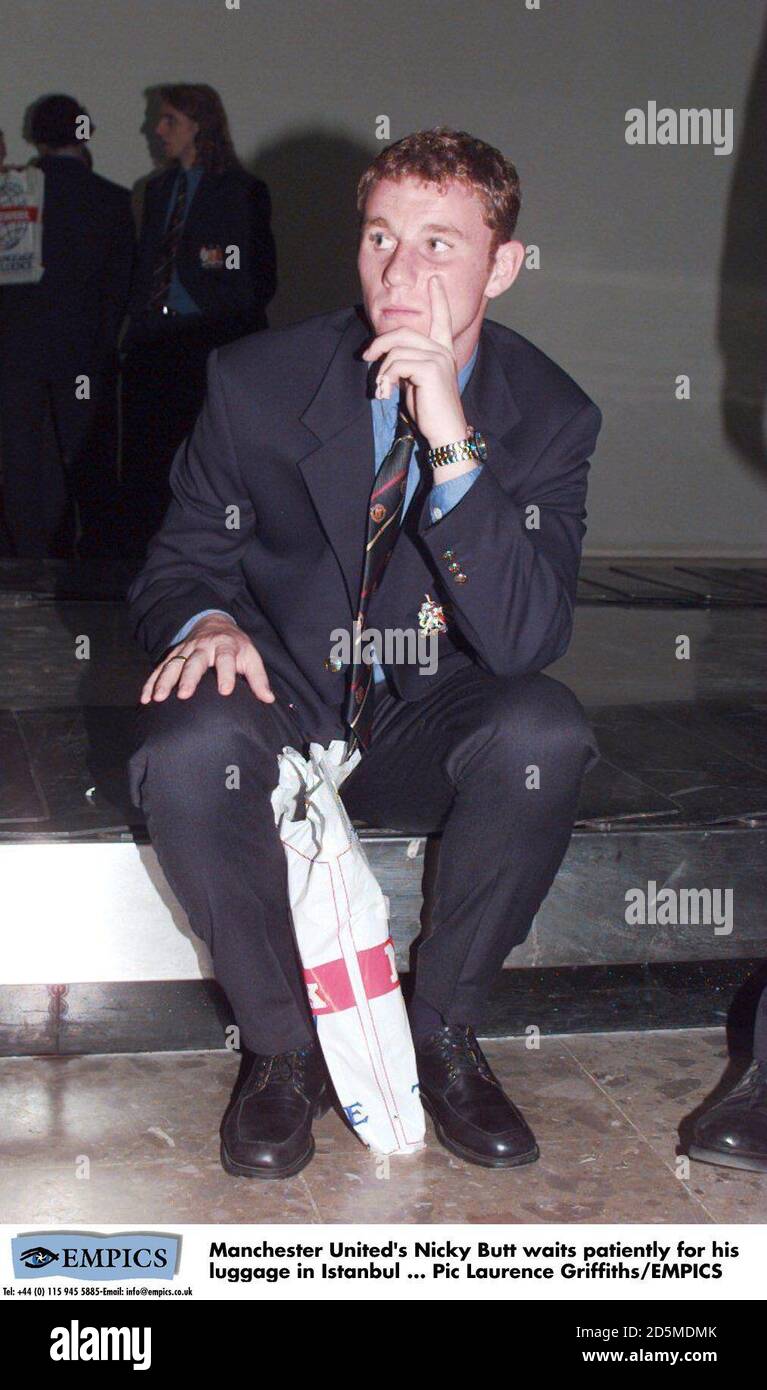 Manchester Uniteds Nicky Butt Waits Patiently For His Luggage In