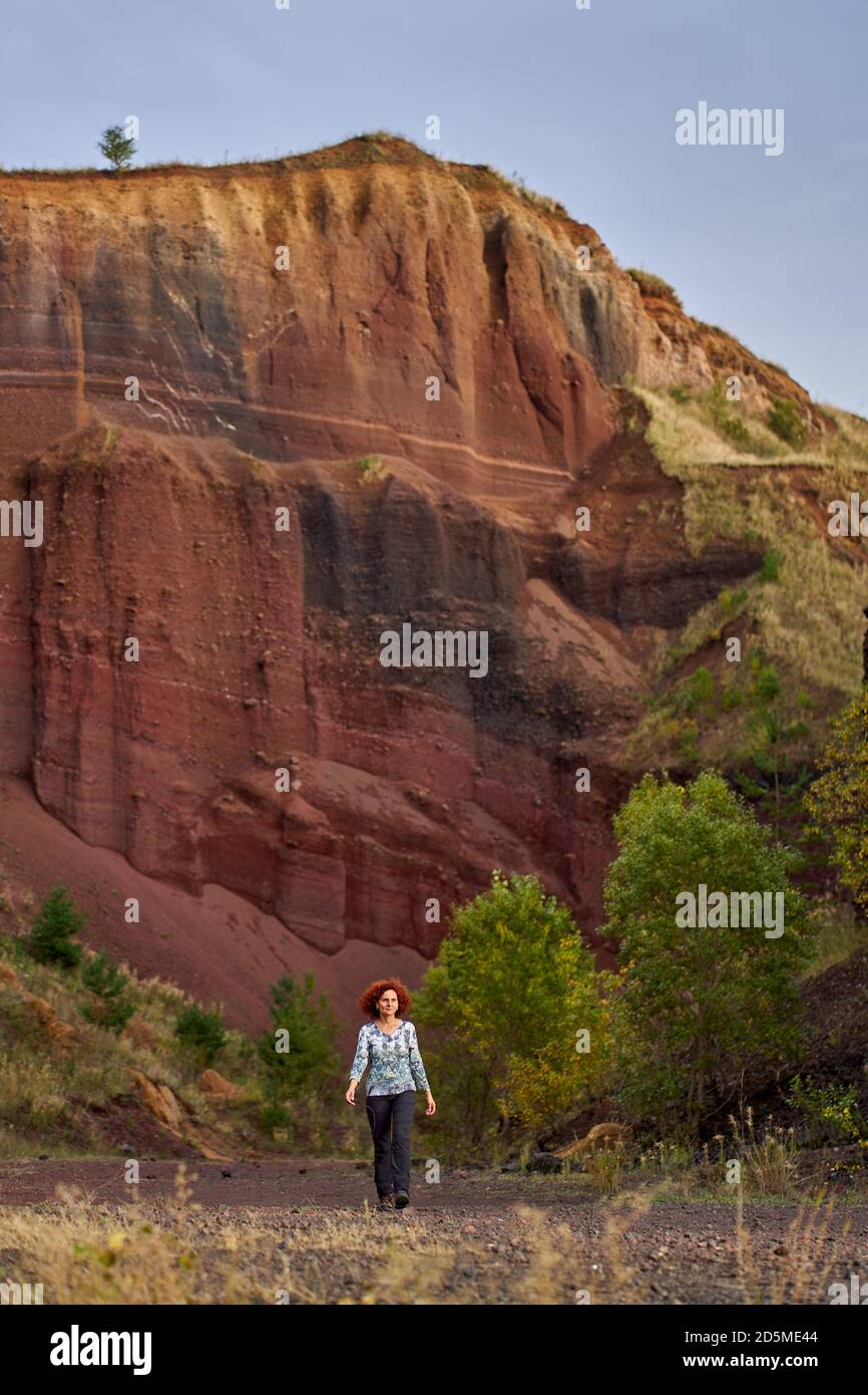 Candid portrait of a beautiful redhead woman inside the caldera of an ...