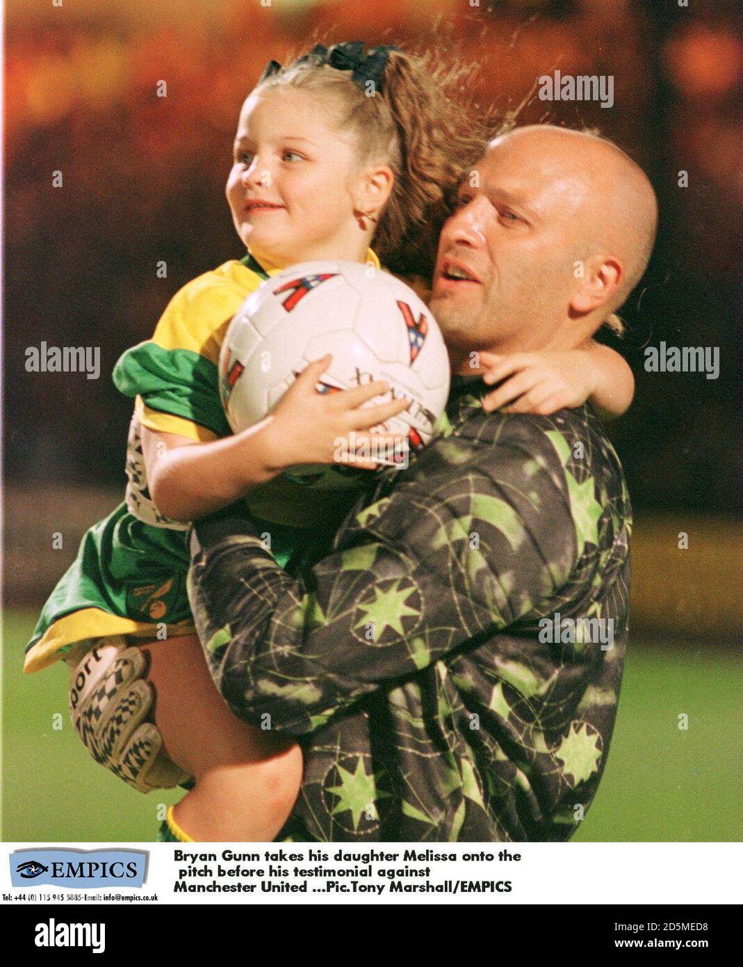 Bryan Gunn takes his daughter Melissa onto the pitch before his ...