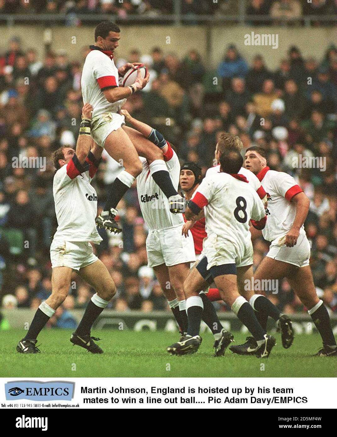 Martin Johnson, England is hoisted up by his team mates to win a line ...