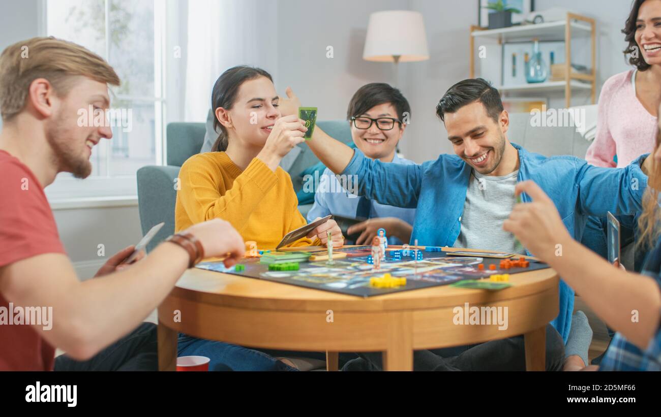 Diverse Group of Guys and Girls Playing in a Strategic Board Game with ...