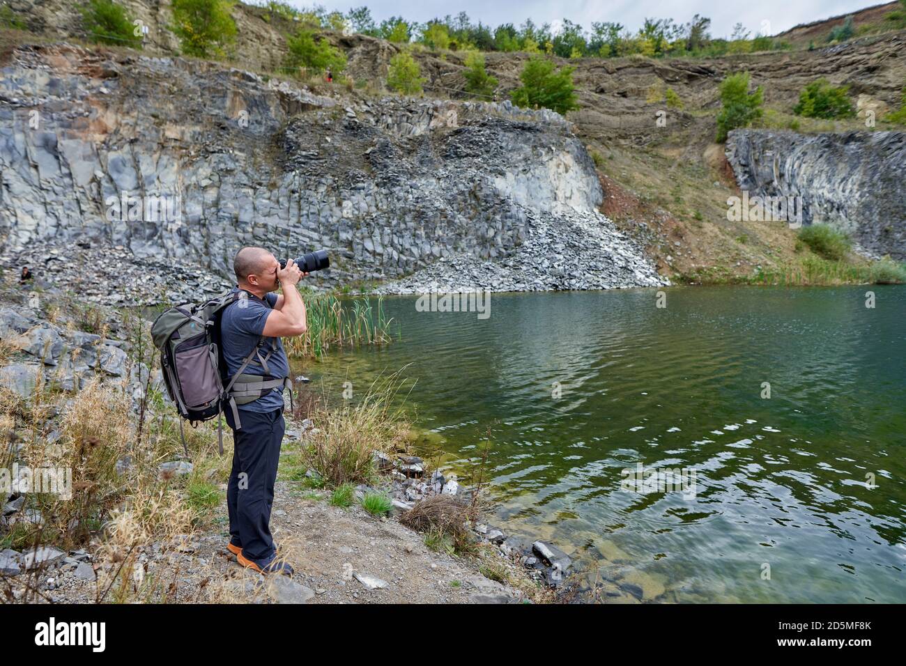 Professional photographer shooting landscape by the lakeside Stock ...