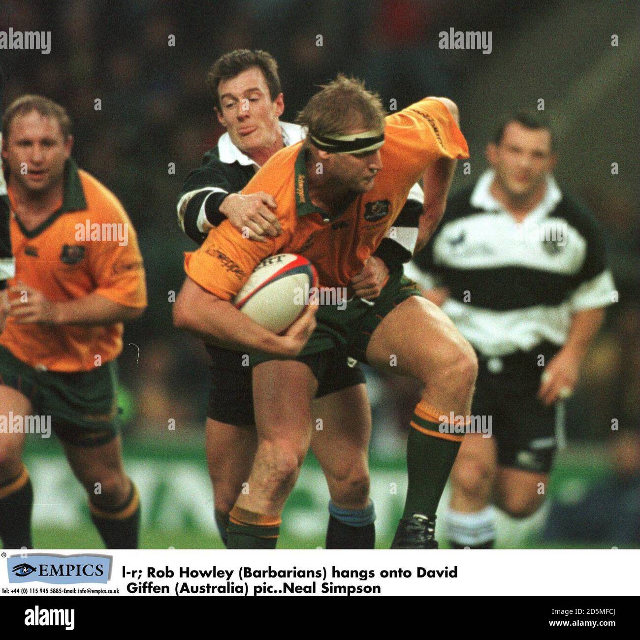 l-r; Rob Howley, Barbarians hangs onto Australia's David Giffen Stock ...
