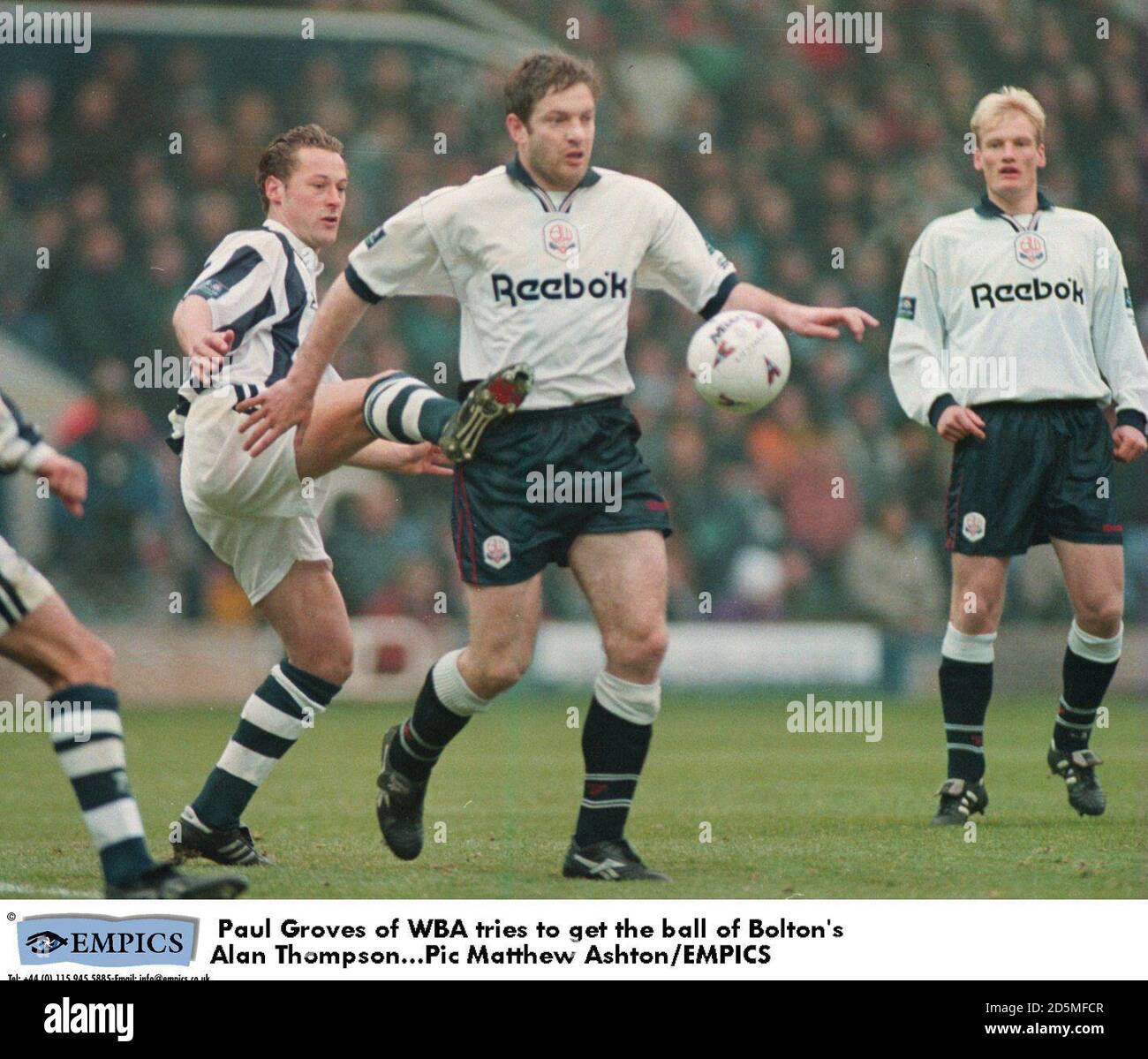 Paul Groves of WBA tries to get the ball of Bolton's Alan Thompson ...