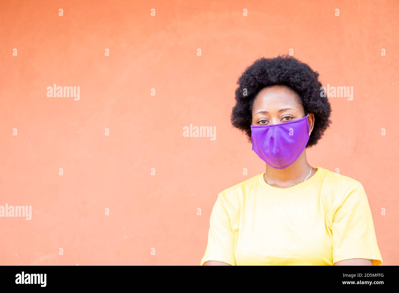 Young black African woman wearing face mask carrying afro hairstyles ...