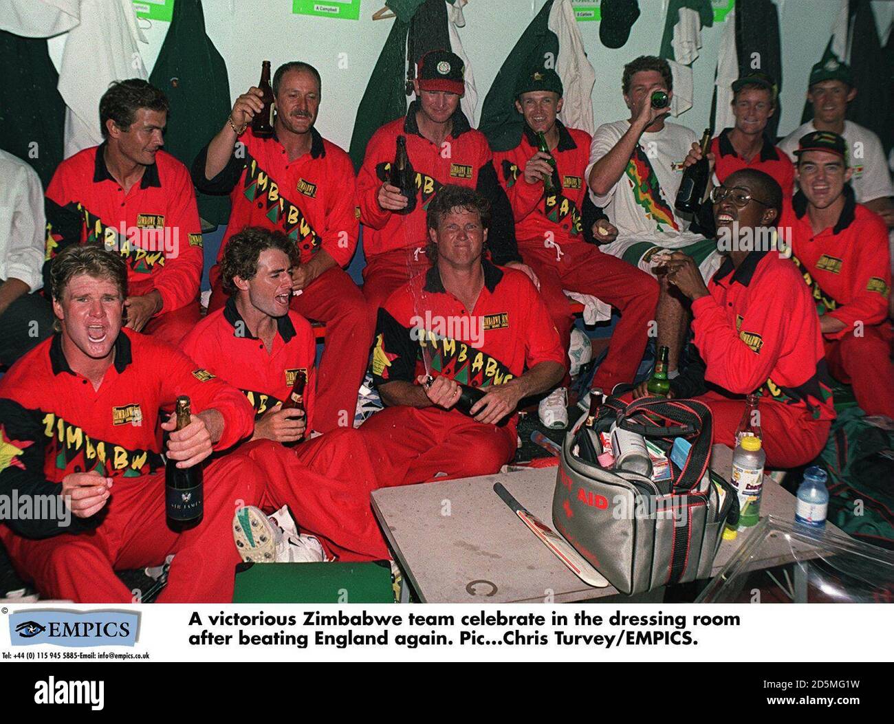 A victorious Zimbabwe team celebrate in the dressing room after beating ...
