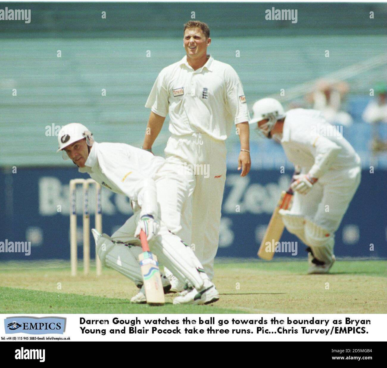 Darren Gough watches the ball go towards the boundary as Bryan Young ...