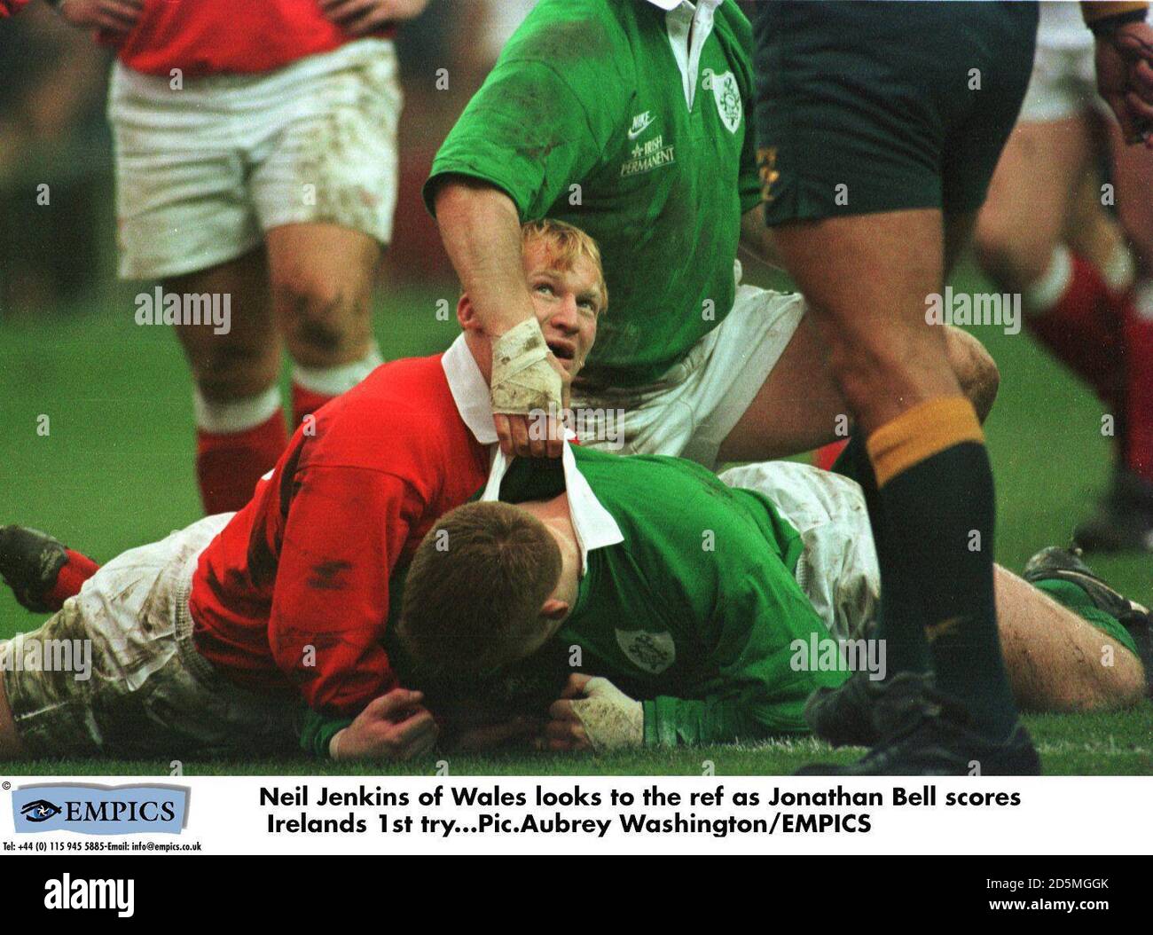 Neil Jenkins of Wales looks to the ref as Jonathan Bell scores Ireland ...