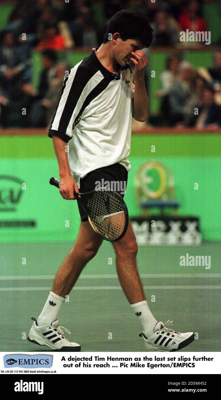 A dejected Tim Henman as the last set slips further out of his reach ...
