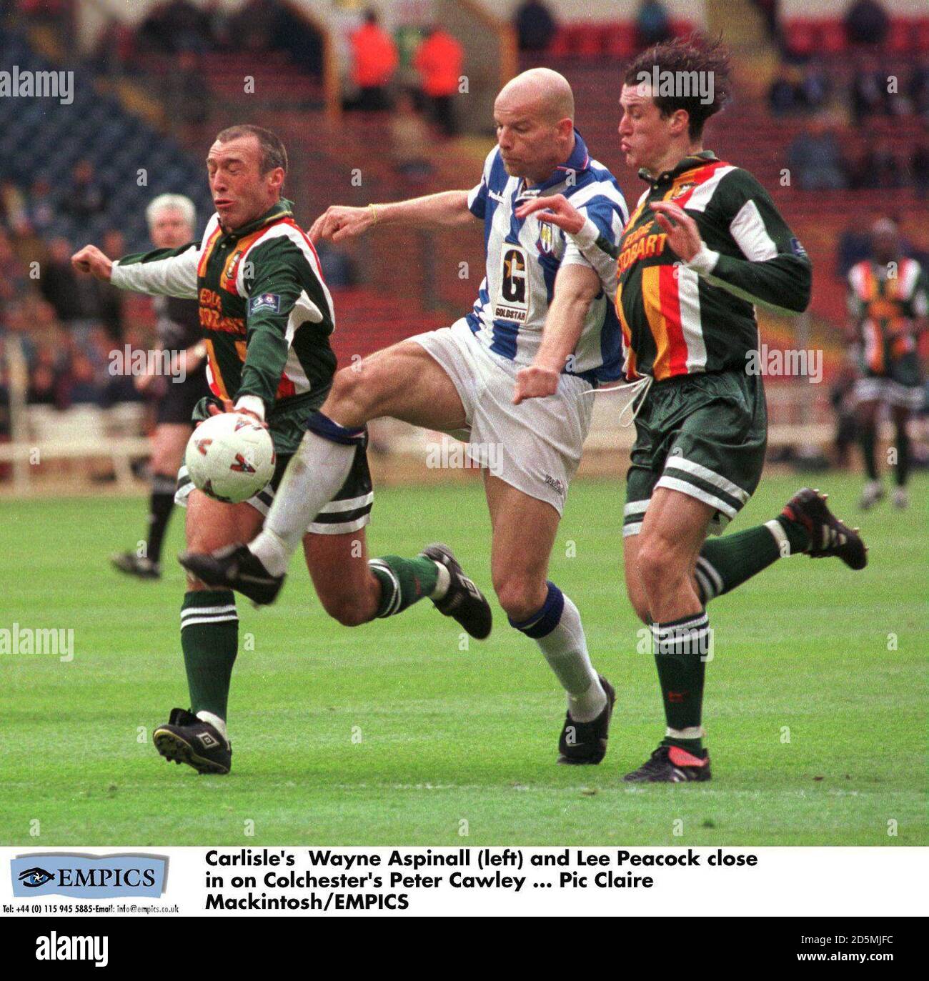 Carlisle's Wayne Aspinall (left) and Lee Peacock close in on Colchester ...