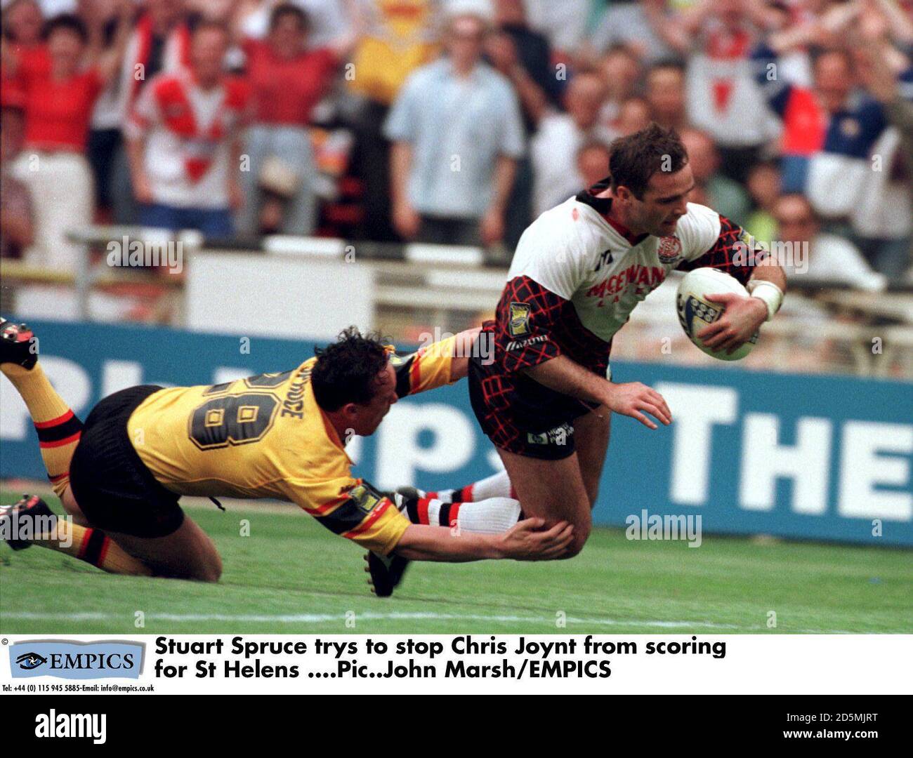 Stuart Spruce trys to stop Chris Joynt from scoring for St Helens Stock ...