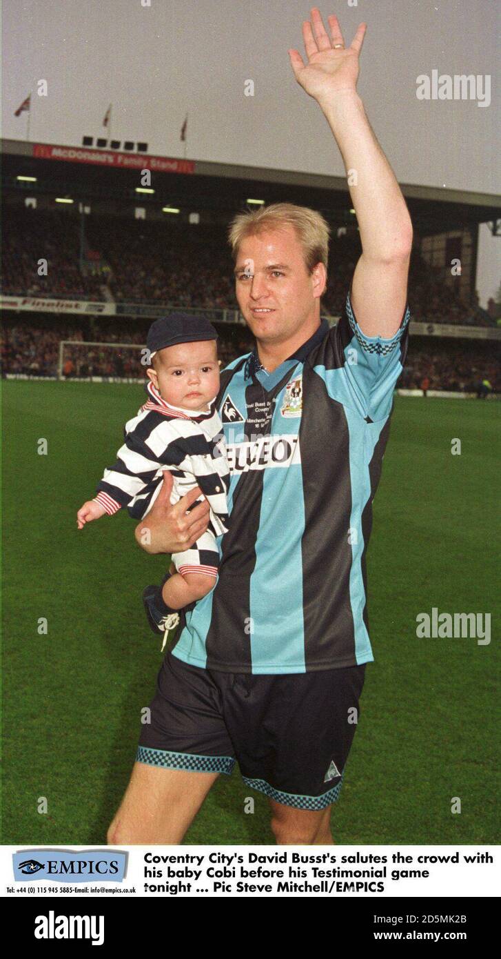 Coventry City's David Busst's salutes the crowd with his baby Cobi ...