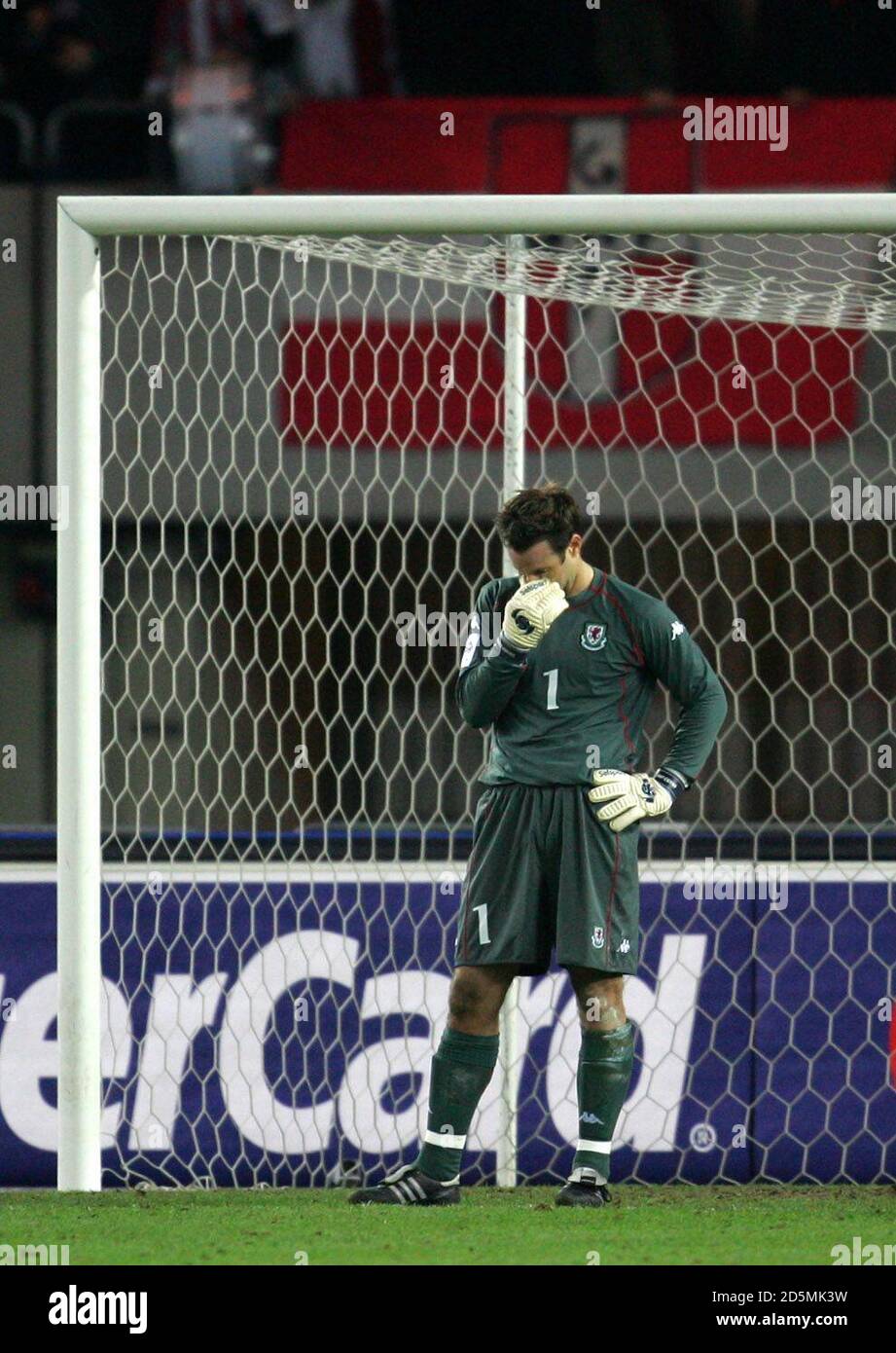Wales goalkeeper Danny Coyne stands dejected after letting in the ...