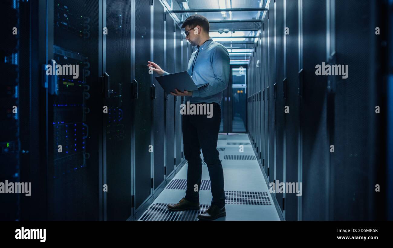 In Data Center IT Engineer Stands Before Working Server Rack Doing ...