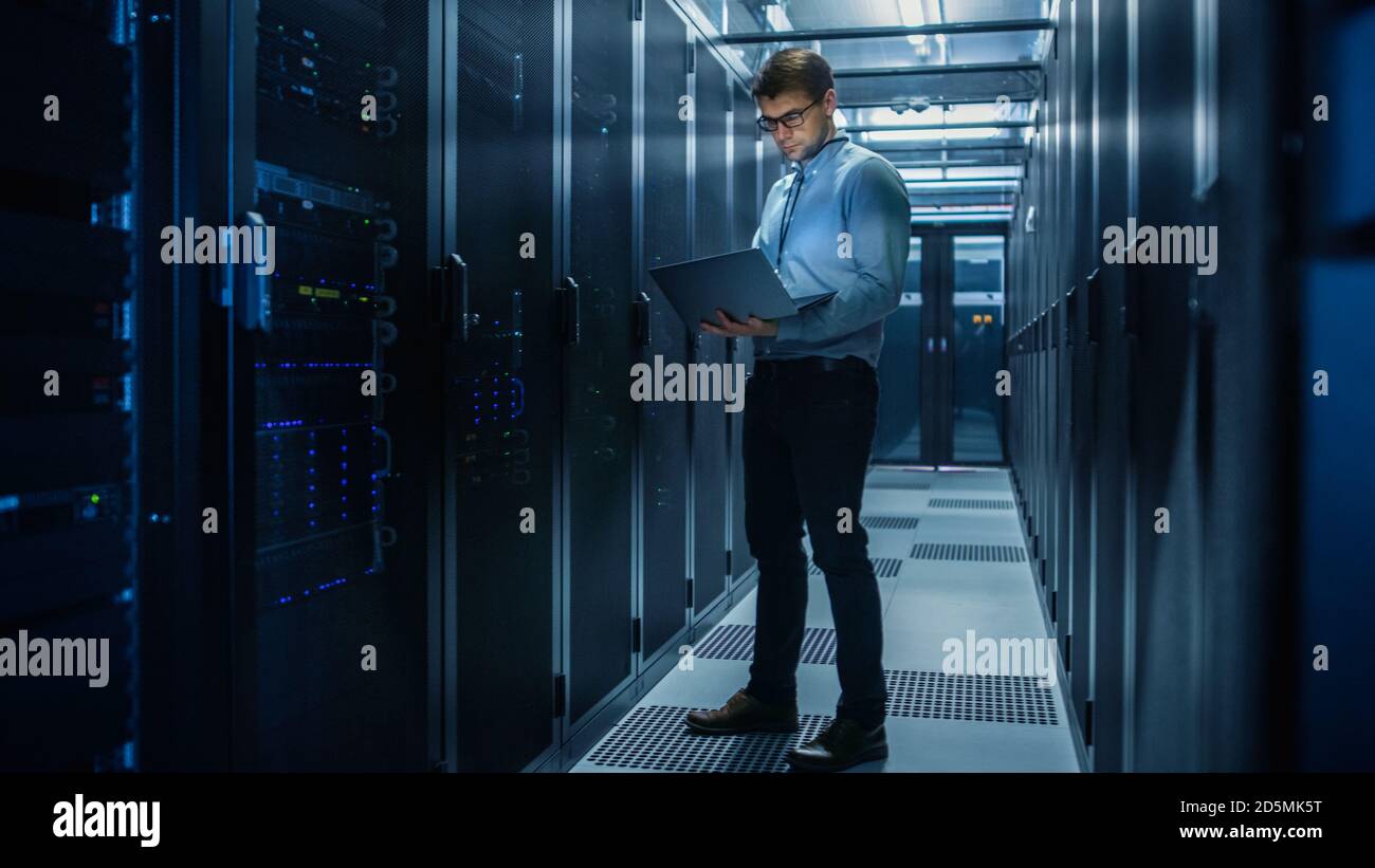 In Data Center IT Engineer Stands Before Working Server Rack Doing ...