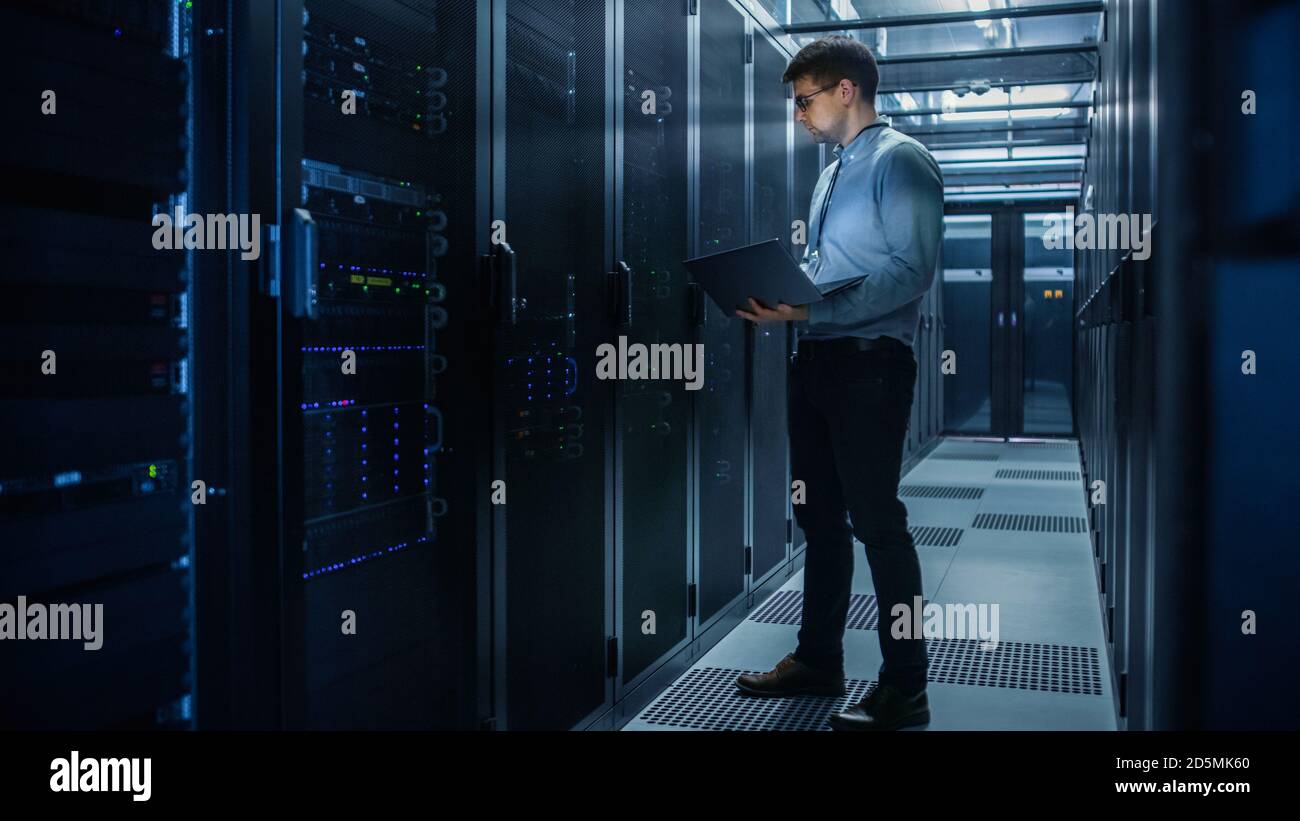 In Data Center IT Engineer Stands Before Working Server Rack Doing ...