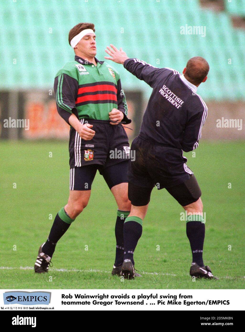 Rob Wainwright avoids a playful swing from teammate Gregor Townsend ...