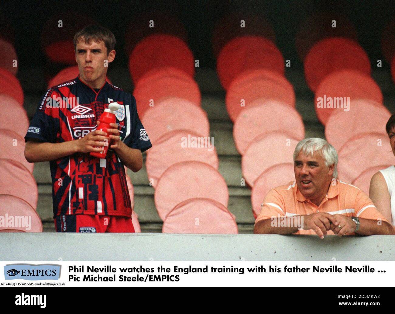 Phil Neville watches the England training with his father Neville ...