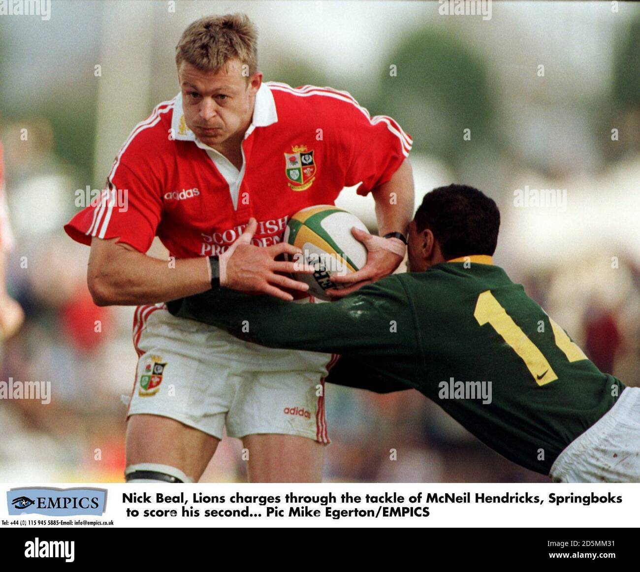 Nick Beal, Lions charges through the tackle of McNeil Hendricks ...