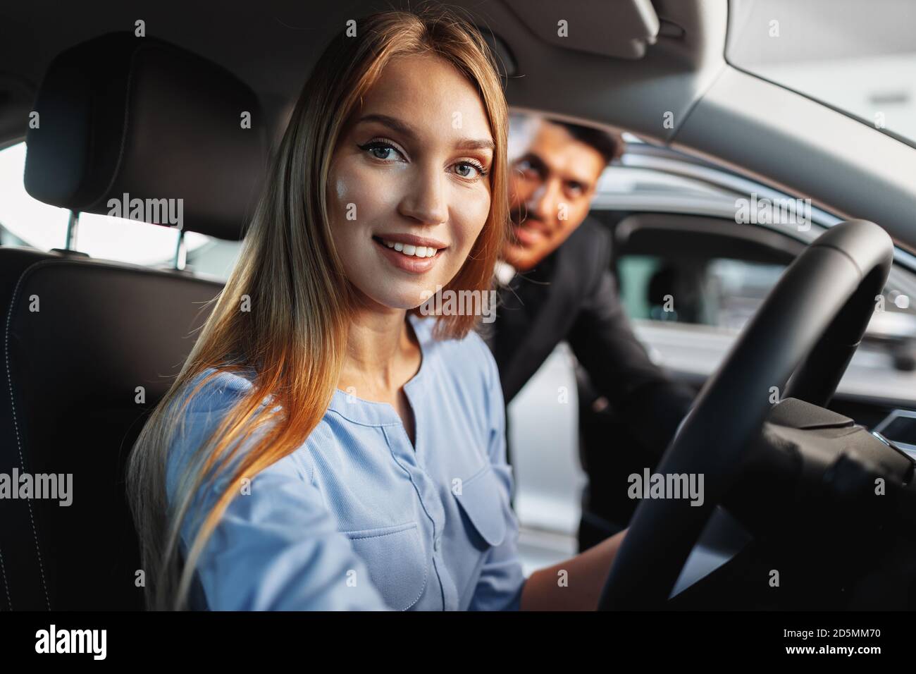 Happy woman new car owner sitting in driver seat Stock Photo - Alamy