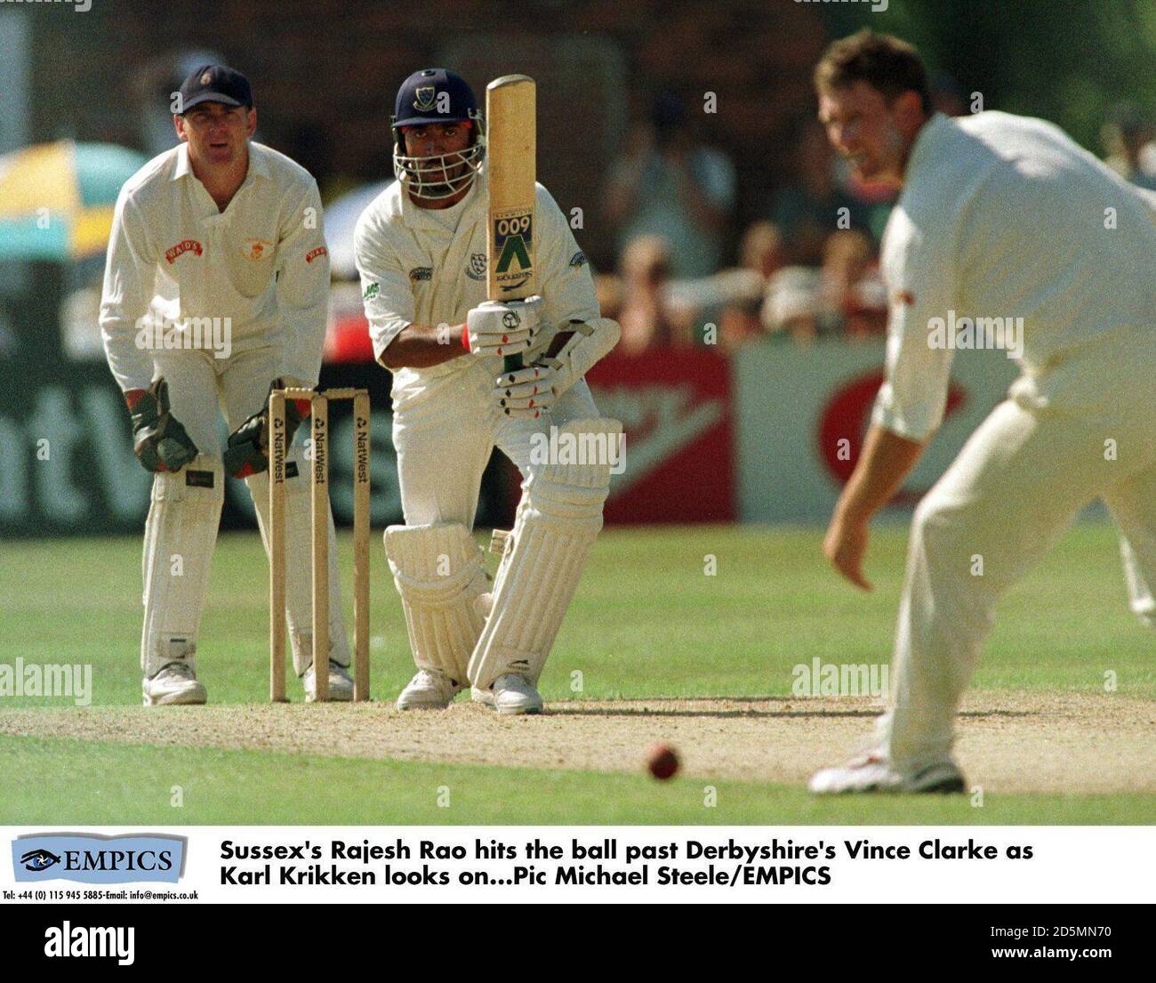 Sussex's Rajesh Rao hits the ball past Derbyshire's Vince Clarke ...