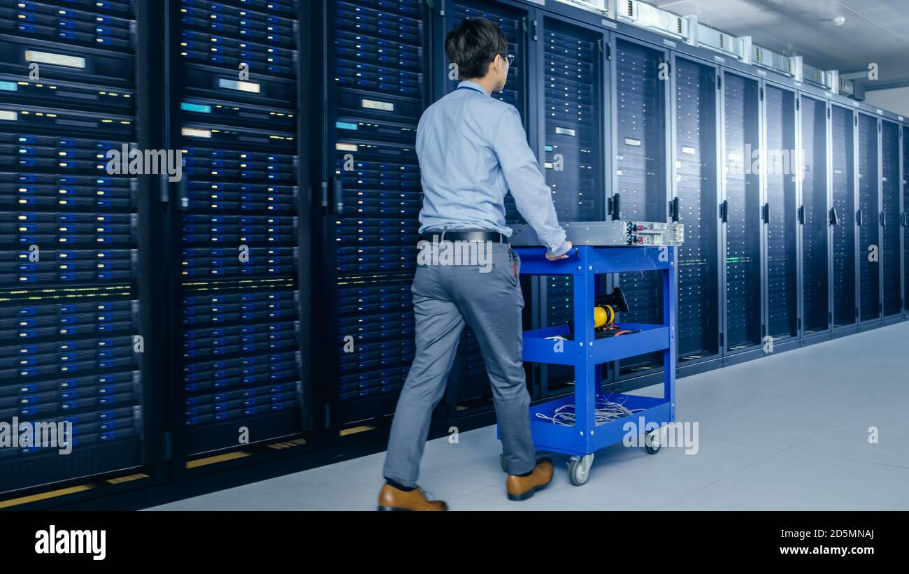 In the Modern Data Center: IT Technician Working with Server Racks ...