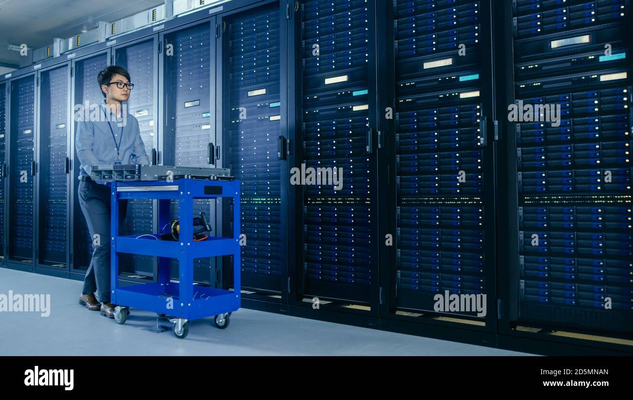 In the Modern Data Center: IT Technician Working with Server Racks ...