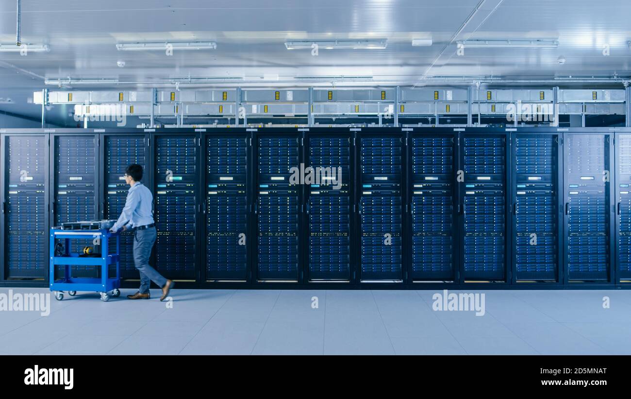 In the Modern Data Center: IT Technician Working with Server Racks ...