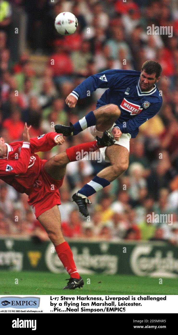 L-r; Steve Harkness, Liverpool is challenged by a flying Ian Marshall ...