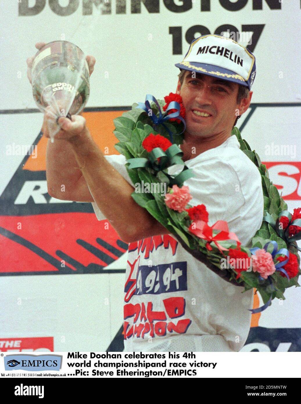 Mike Doohan celebrates winning the race and his fourth world ...