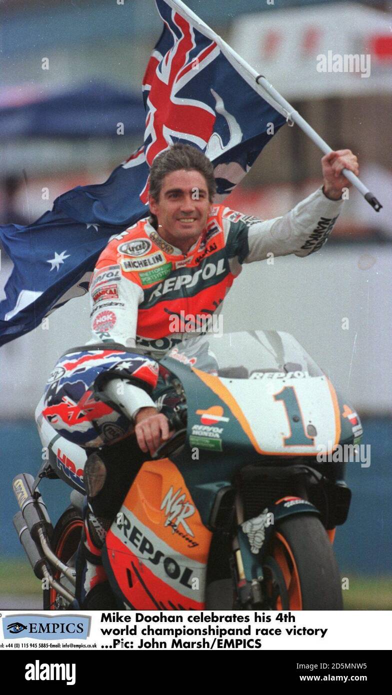 Mike Doohan celebrates winning the race and his fourth world ...