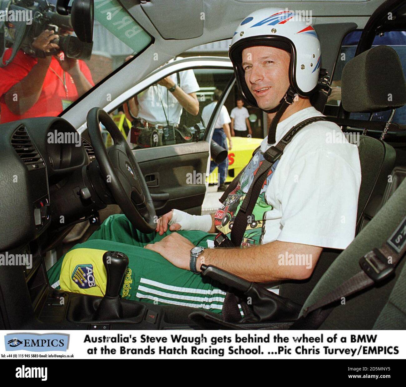 Australia's Steve Waugh gets behind the wheel of a BMW at the Brands ...
