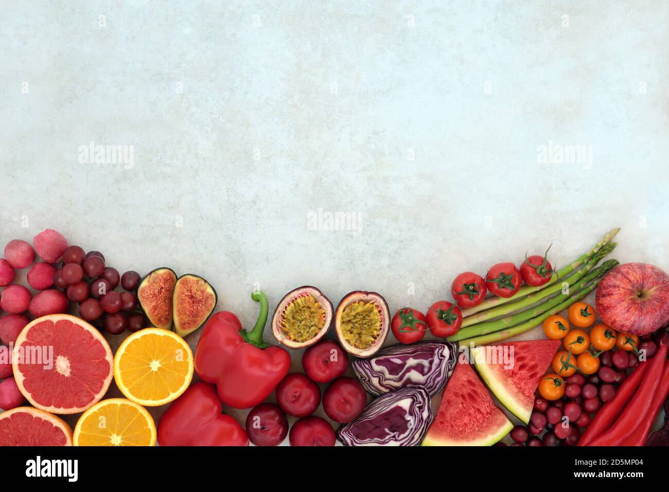 Fruit & vegetable border on mottled background. High in lycopene and ...