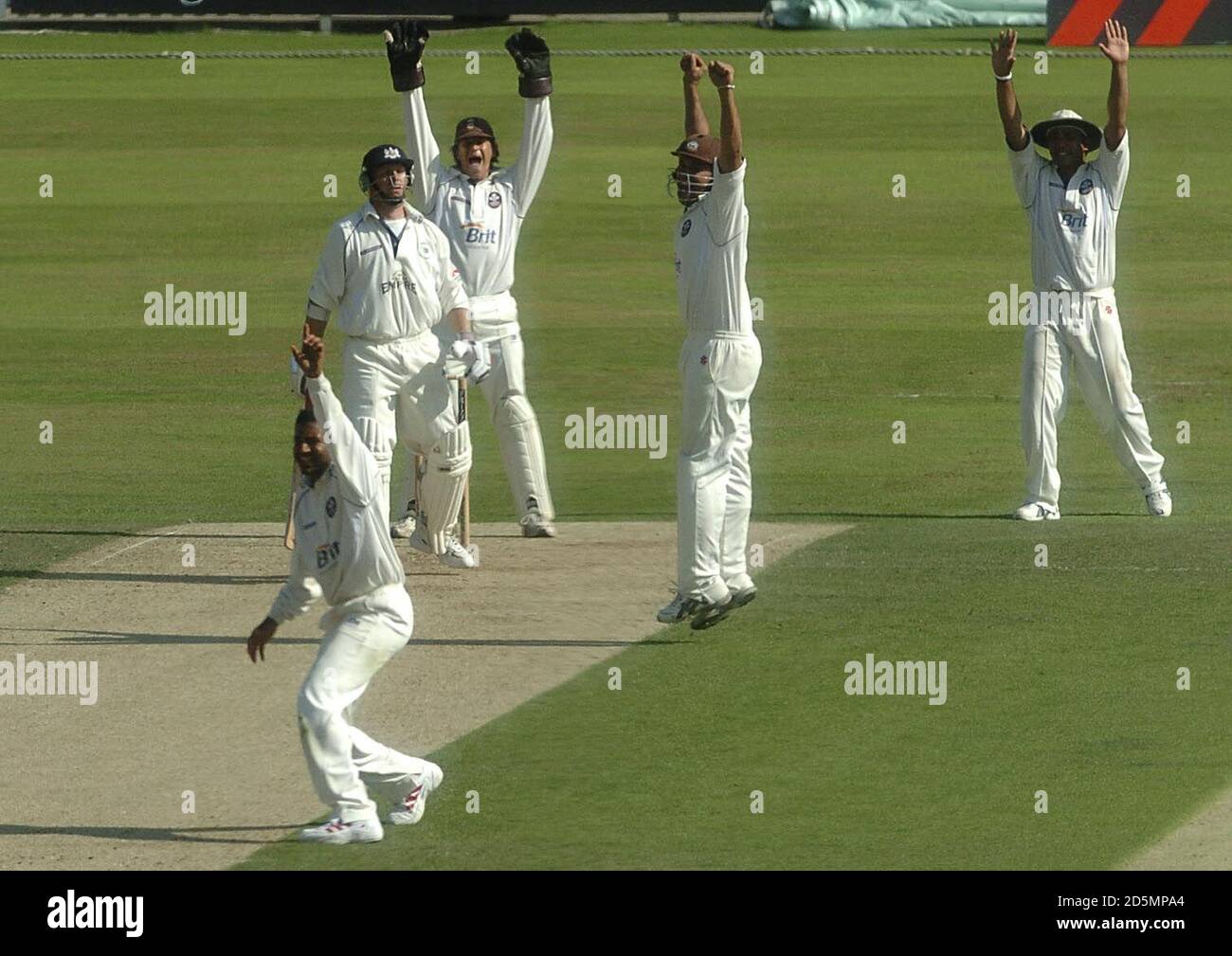 Surrey's Nayan Doshi celebrates claiming the wicket of Gloucestershire ...