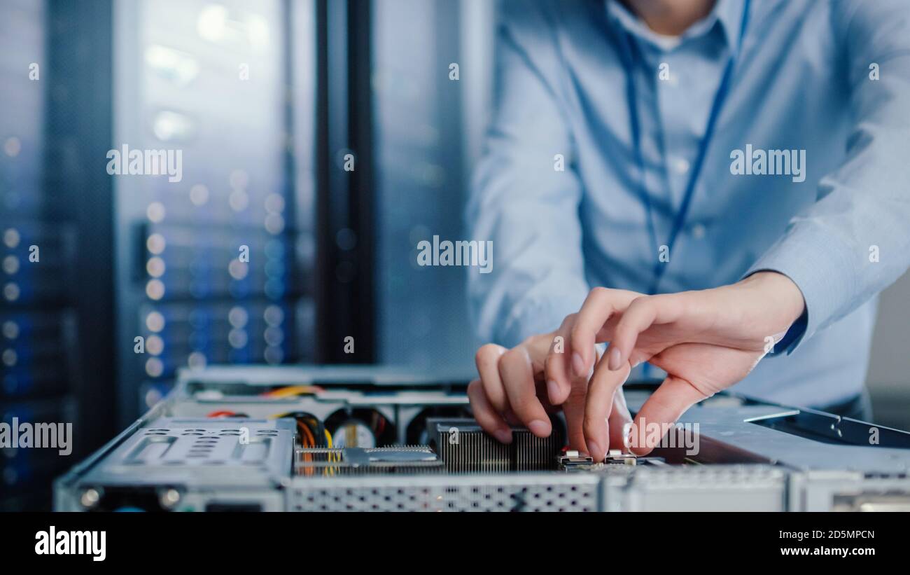 Close-up Shot in Modern Data Center: IT Engineer Installs New Hardware ...