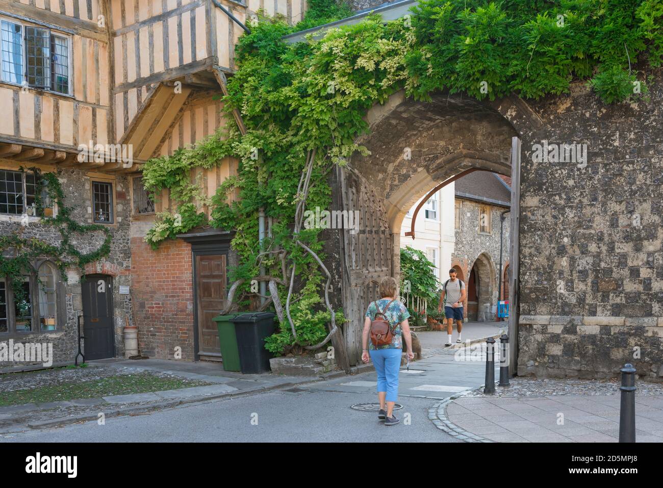 Winchester Priory Gate, view in summer of people passing through the ...