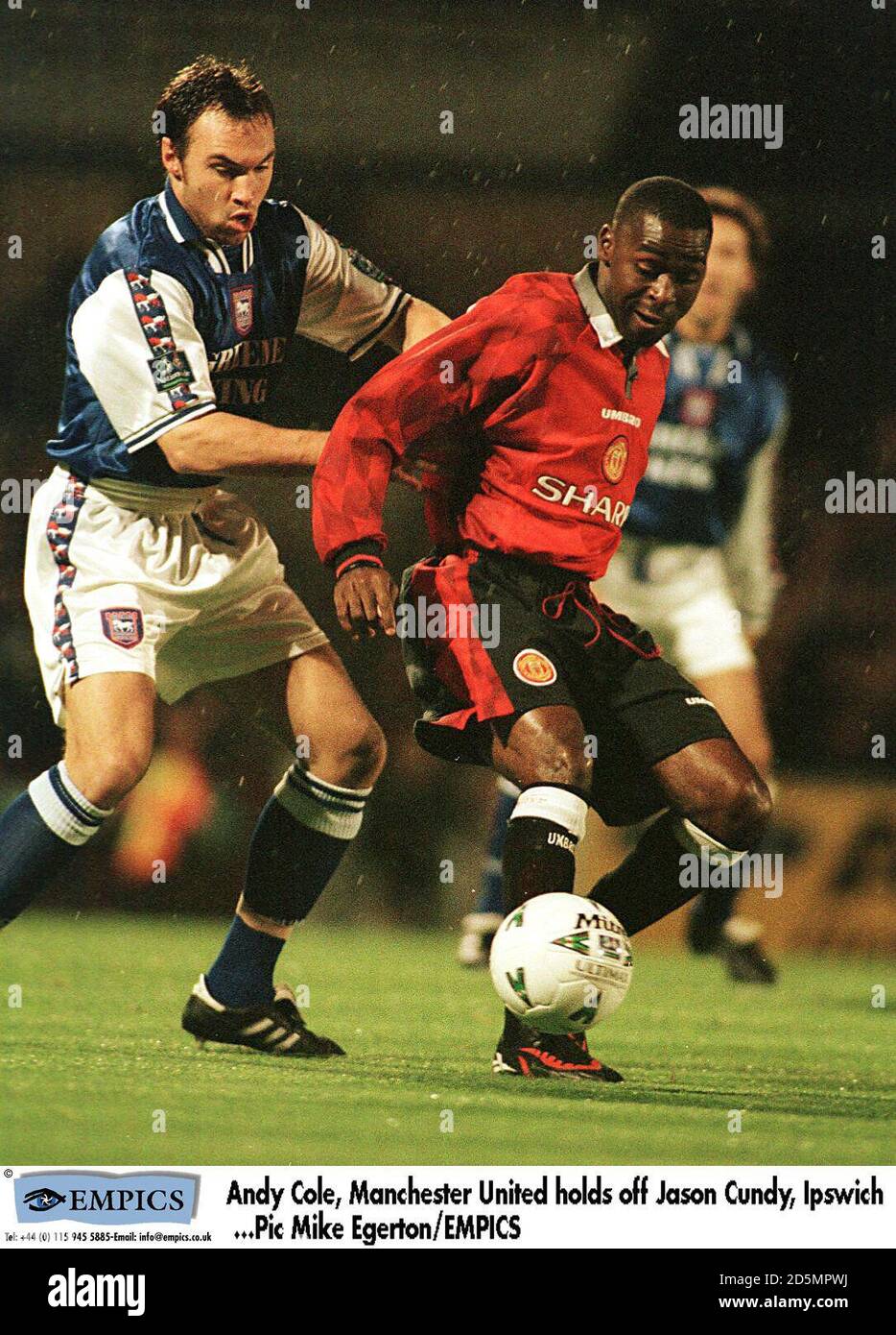 Andy Cole of Manchester United (right) holds off Jason Cundy of Ipswich ...