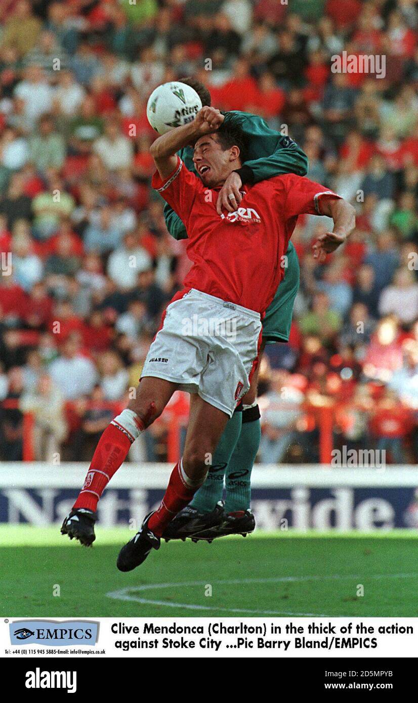 Clive Mendonca of Charlton Athletic (front) is beaten to this header ...