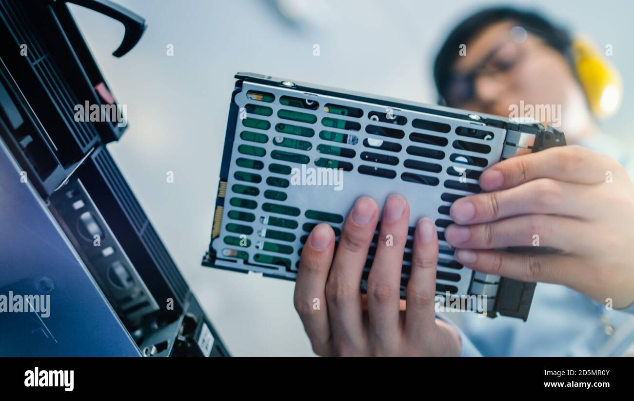 In the Data Center: IT Engineer Installs New HDD Hard Drive and Other ...
