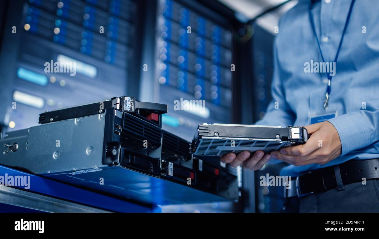 In the Modern Data Center: IT Engineer is Holding New HDD Hard Drive ...