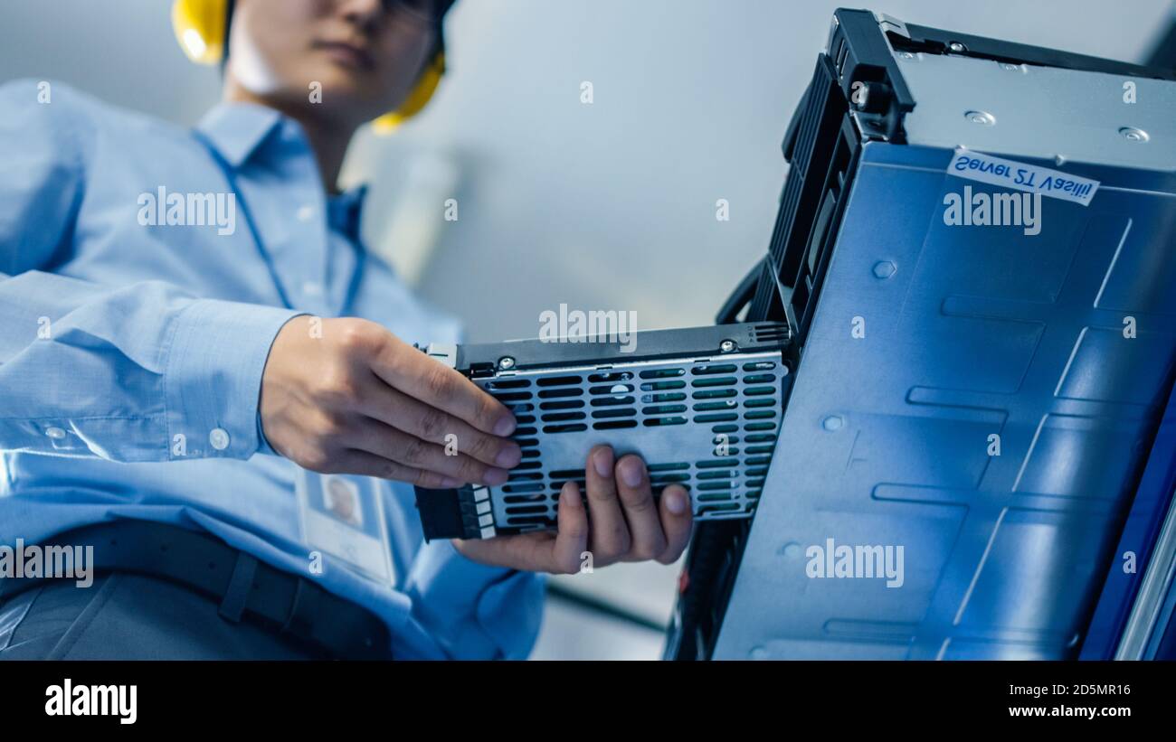 In the Data Center: IT Engineer Installs New HDD Hard Drive and Other ...