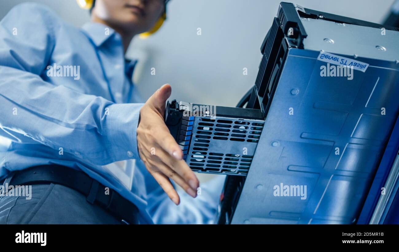 In the Data Center: IT Engineer Installs New HDD Hard Drive and Other ...