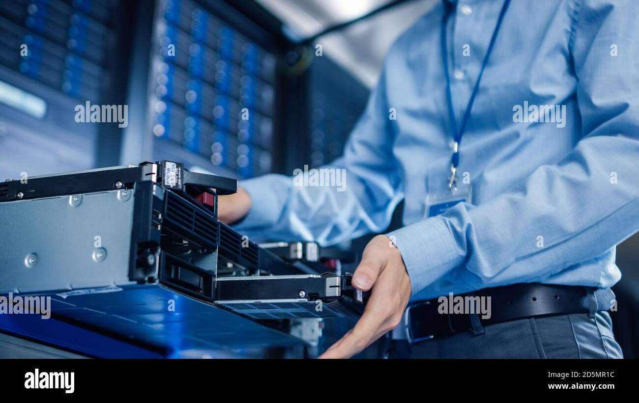 In the Modern Data Center: IT Engineer Installs New HDD Hard Drive and ...