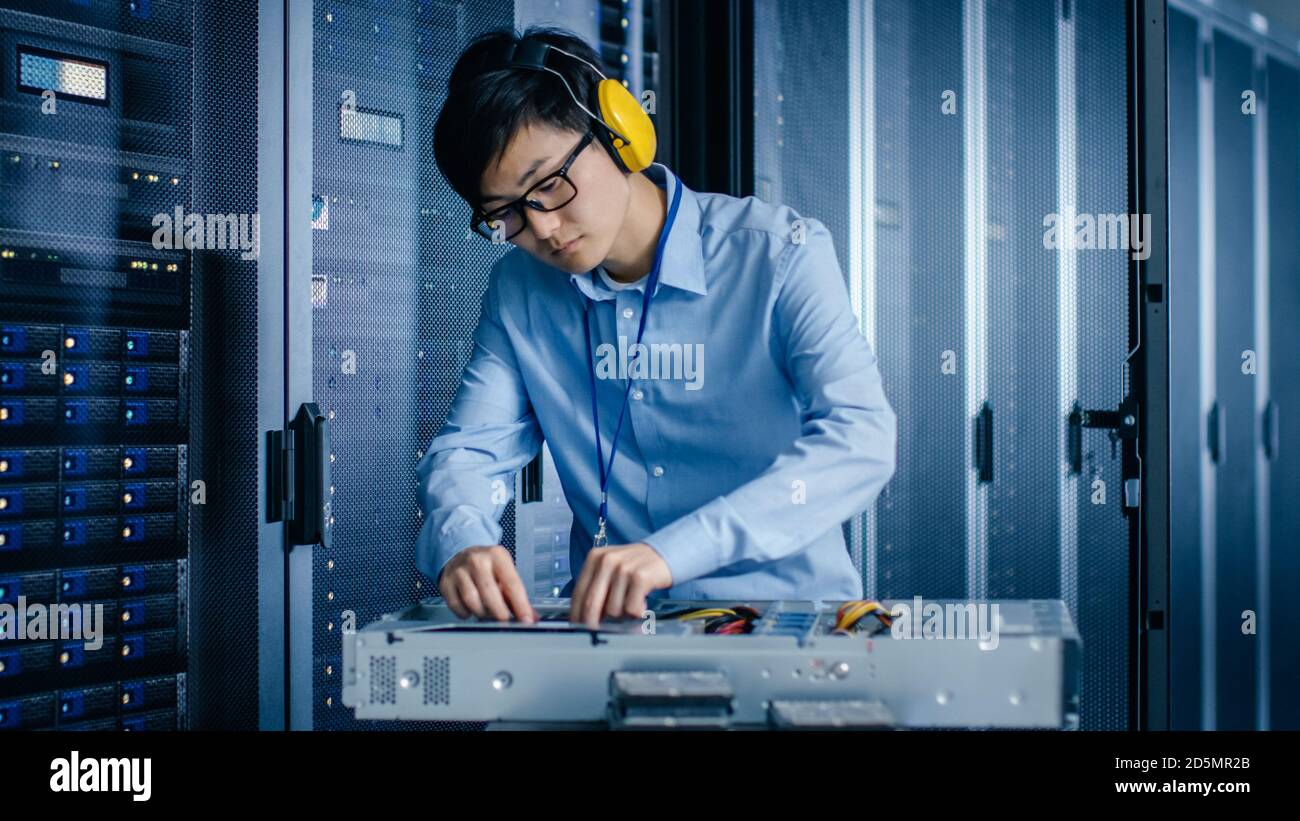 In the Modern Data Center: IT Engineer Wearing Protective Muffs ...