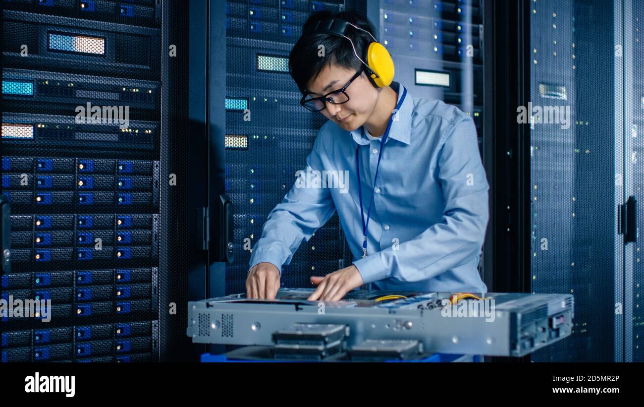 In the Modern Data Center: IT Engineer Wearing Protective Muffs ...