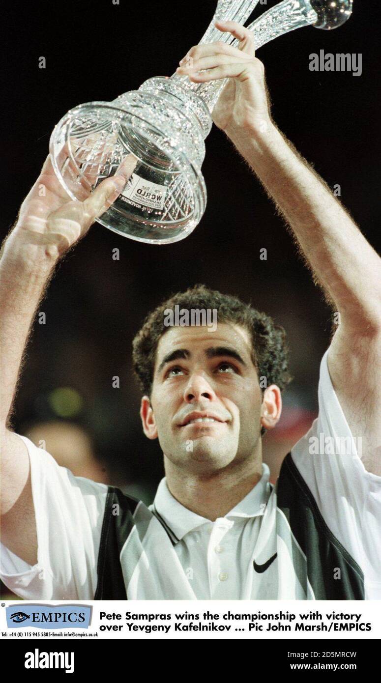 Pete Sampras looks up at the championship trophy which he has just won ...