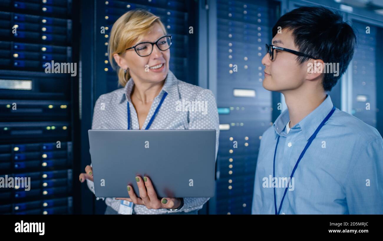 In the Modern Data Center: Engineer and IT Specialist Walking alongside ...