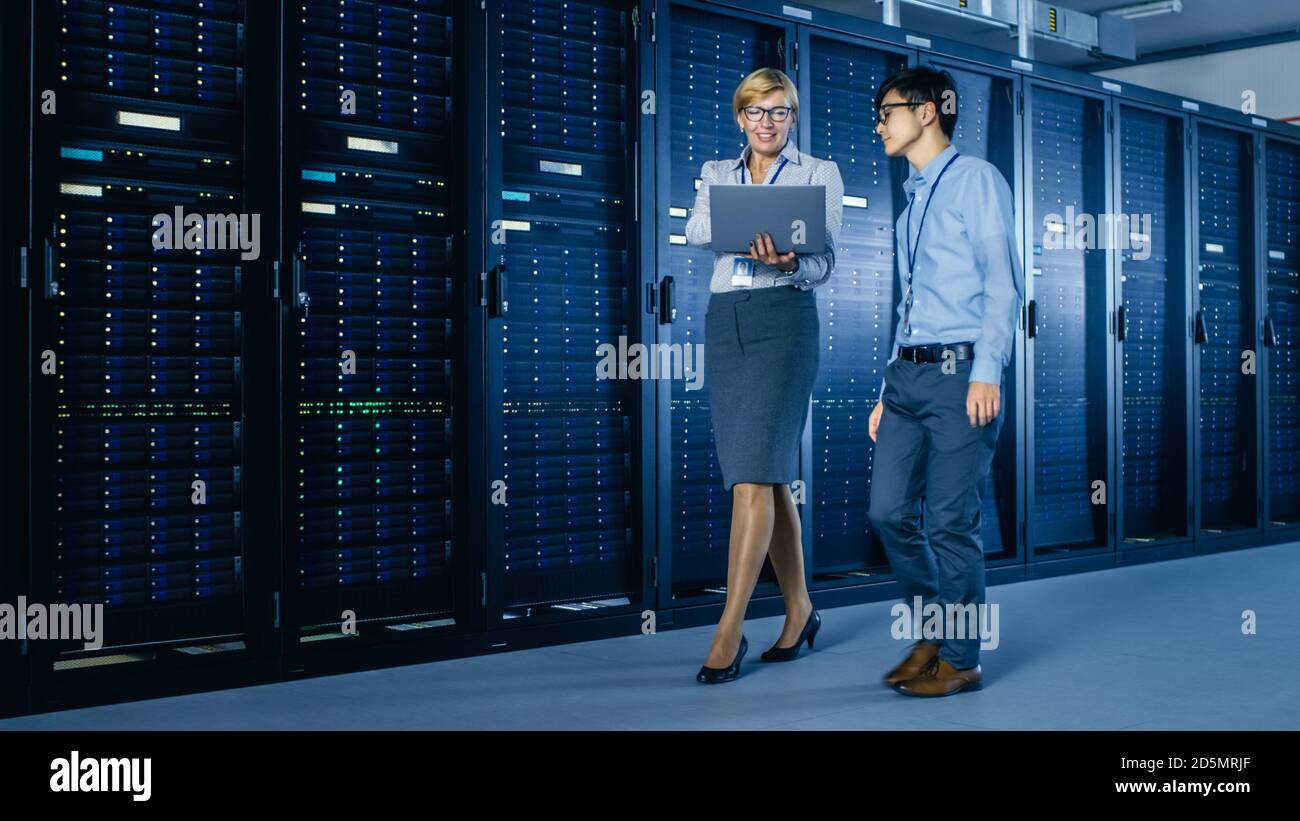 In the Modern Data Center: Engineer and IT Specialist Work with Server ...