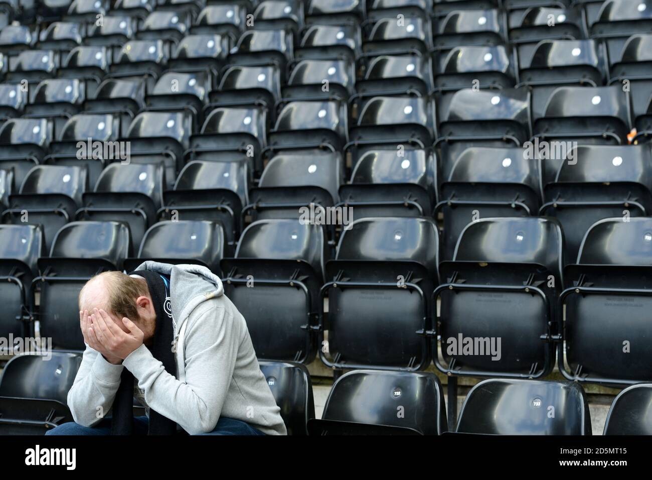 A derby County fan in the stands appears dejected after the final ...