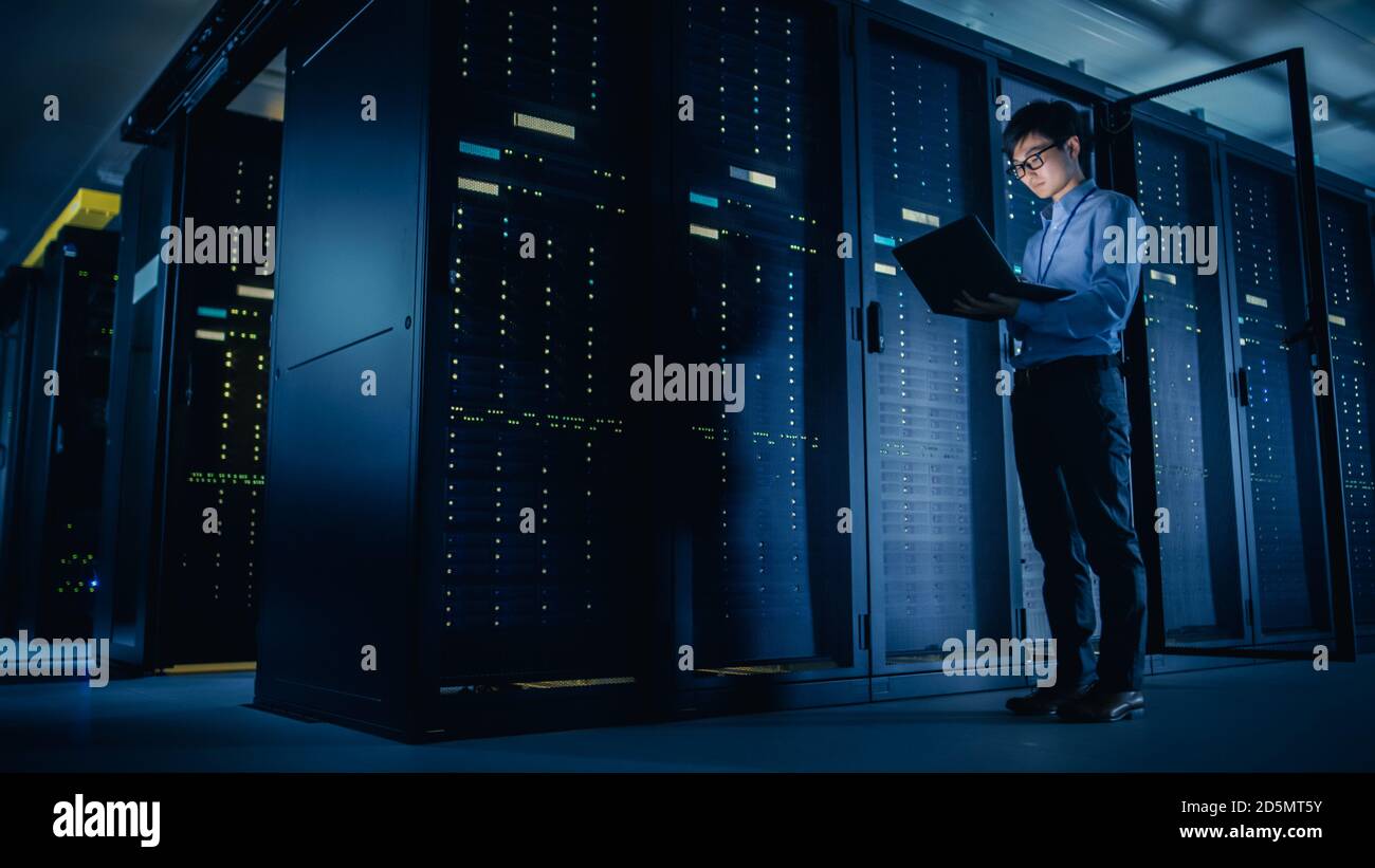 In Data Center: Male IT Technician Running Maintenance Programme on a ...